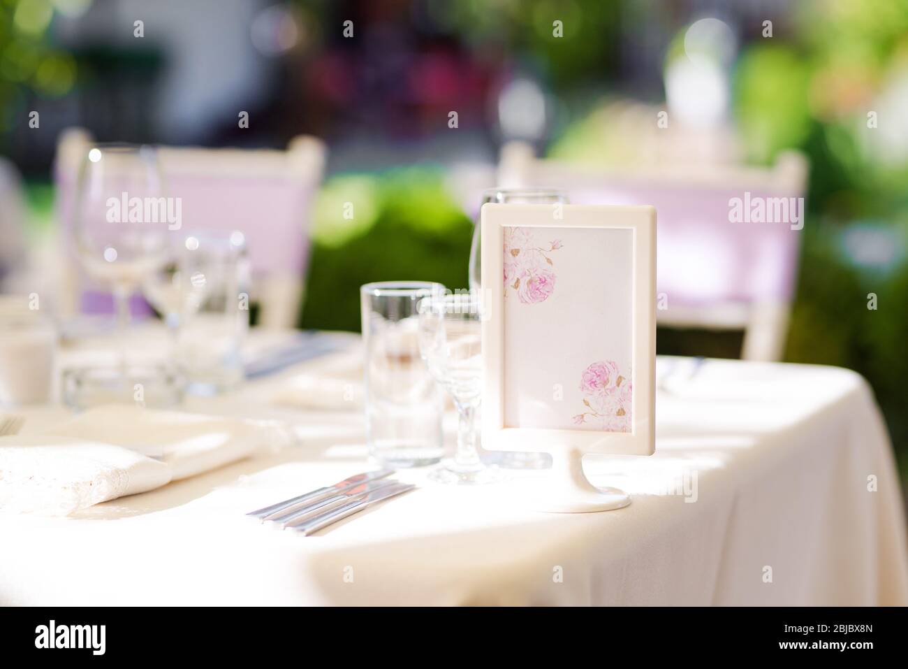 Wedding table set up and a blank table sign Stock Photo - Alamy