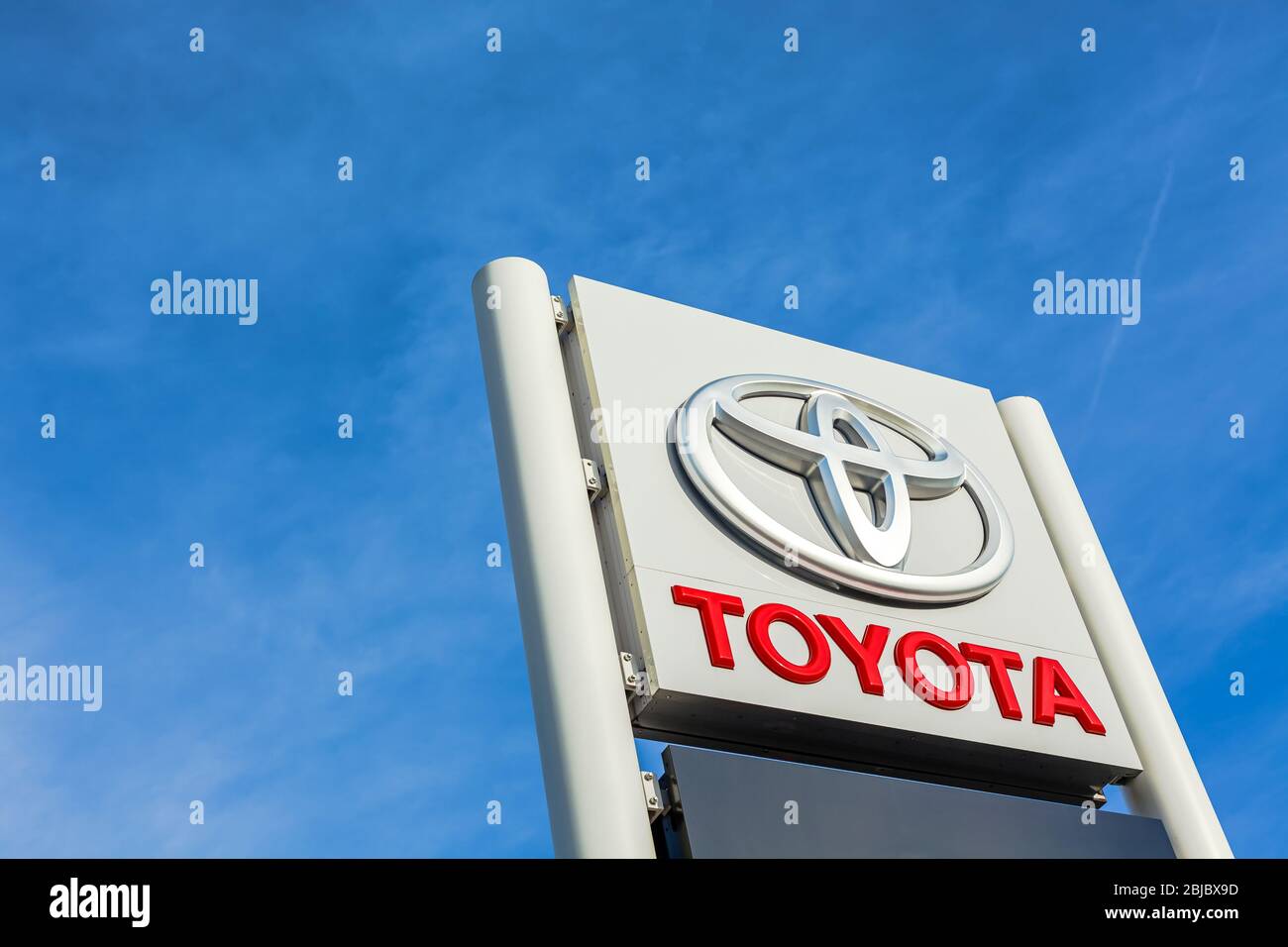 Toyota Motor Corporation brand logo on bright blue sky background ...