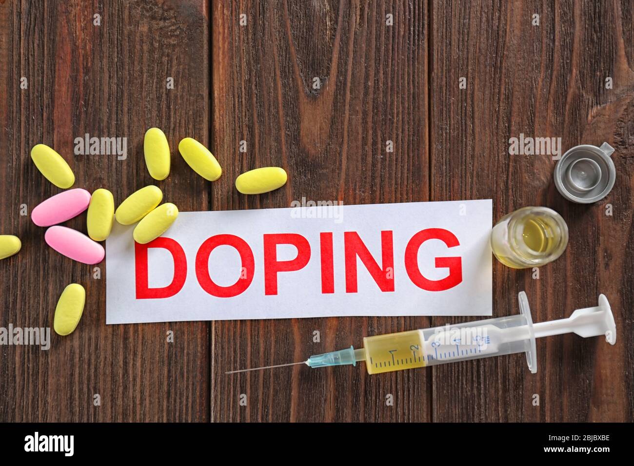 Word Doping and syringe on wooden background Stock Photo - Alamy