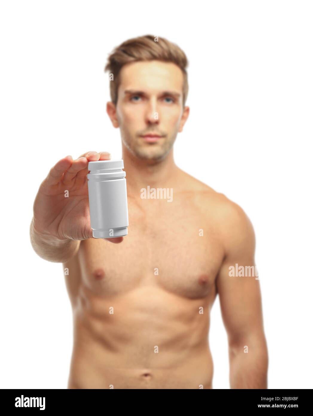 Muscular man holding drugs on white background Stock Photo - Alamy
