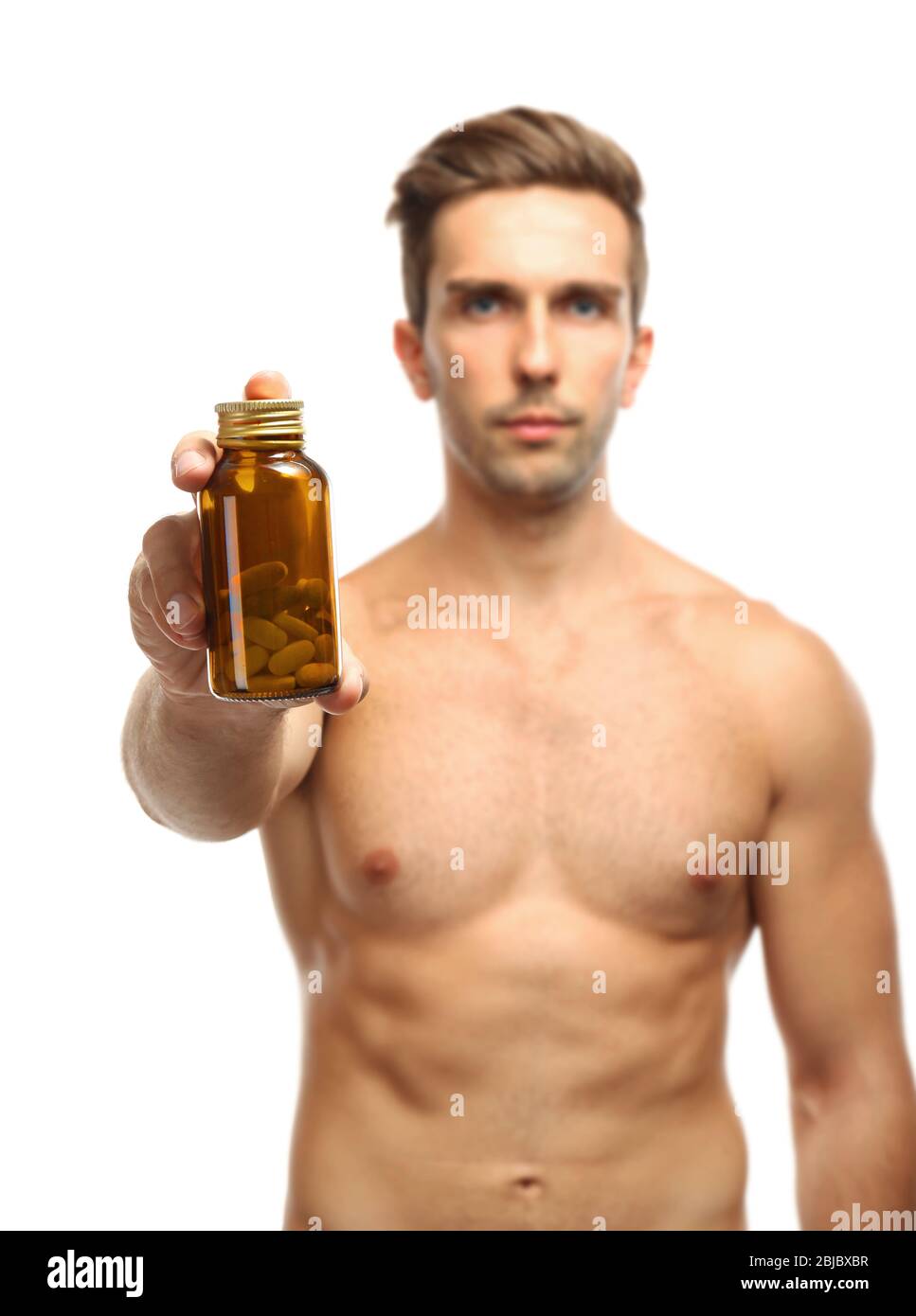 Muscular man holding drugs on white background Stock Photo - Alamy