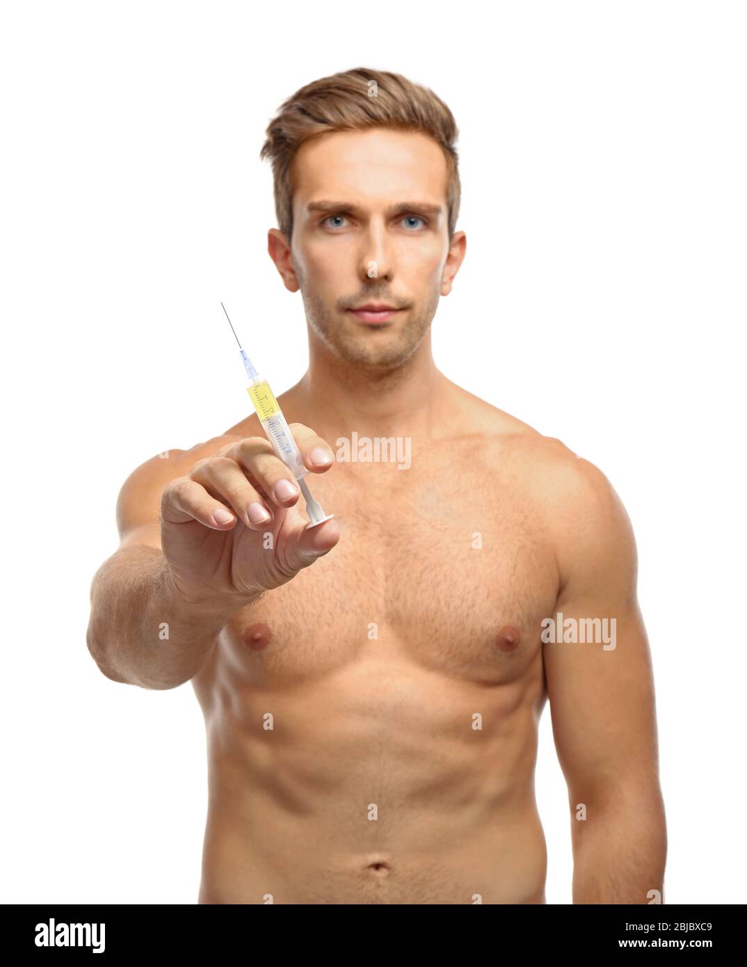 Muscular man holding syringe on white background Stock Photo - Alamy