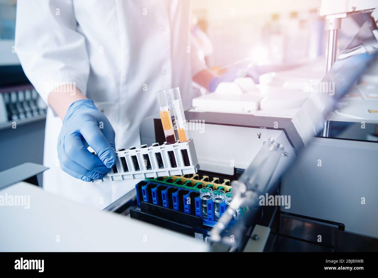 Medical worker in laboratory places blood sample for examination in ...