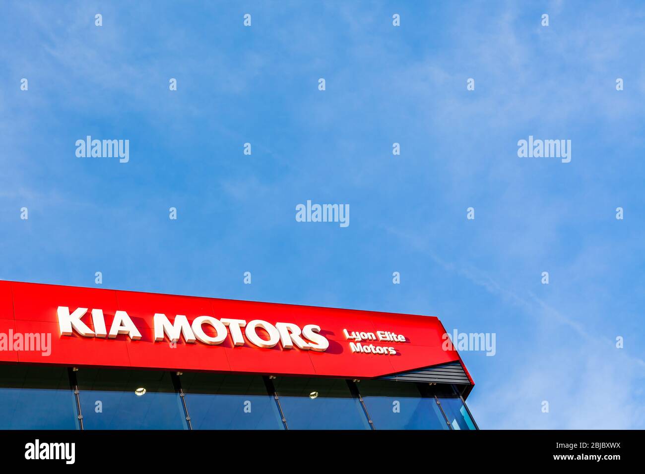 Kia motors corporation brand logo on bright blue sky background located on its dealer office ...