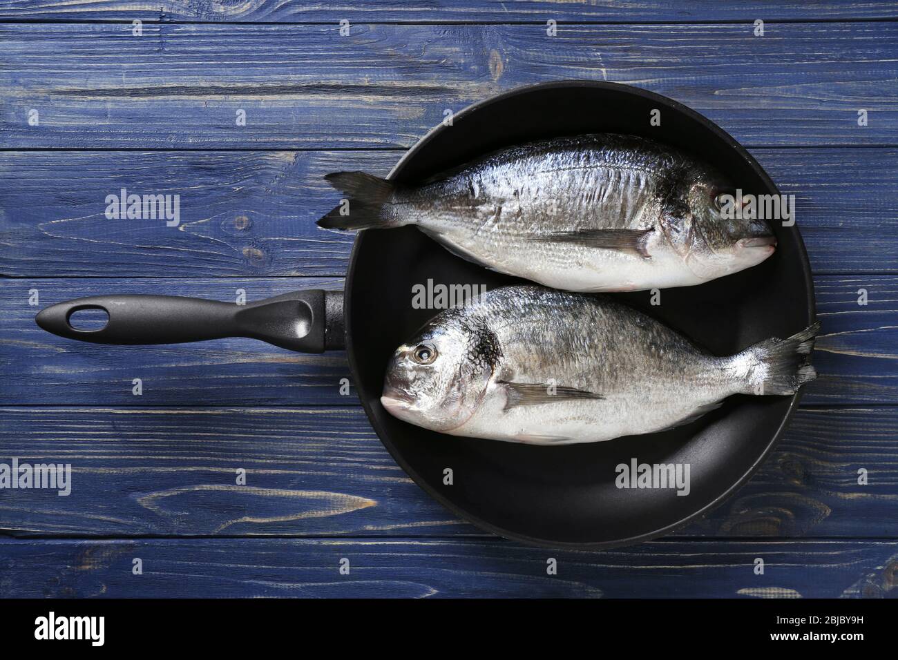 Raw fish on pan Stock Photo - Alamy