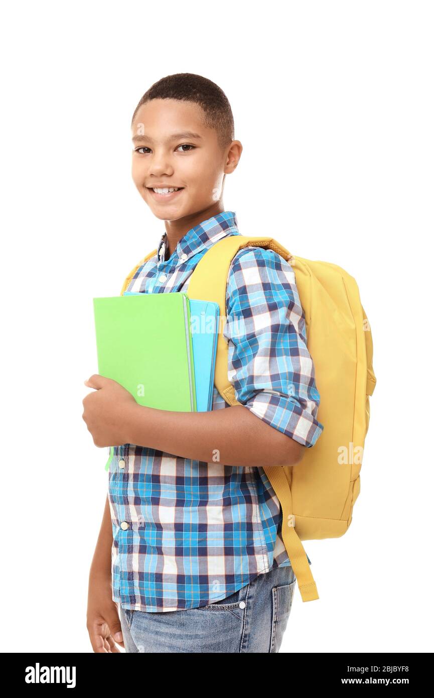 Cheerful teenager boy holding notebooks on white background Stock Photo ...