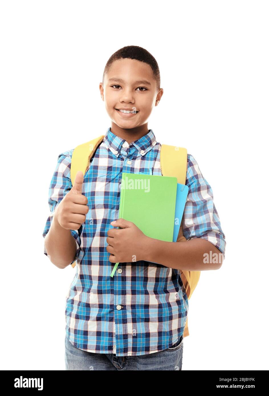Cheerful teenager boy holding notebooks on white background Stock Photo ...