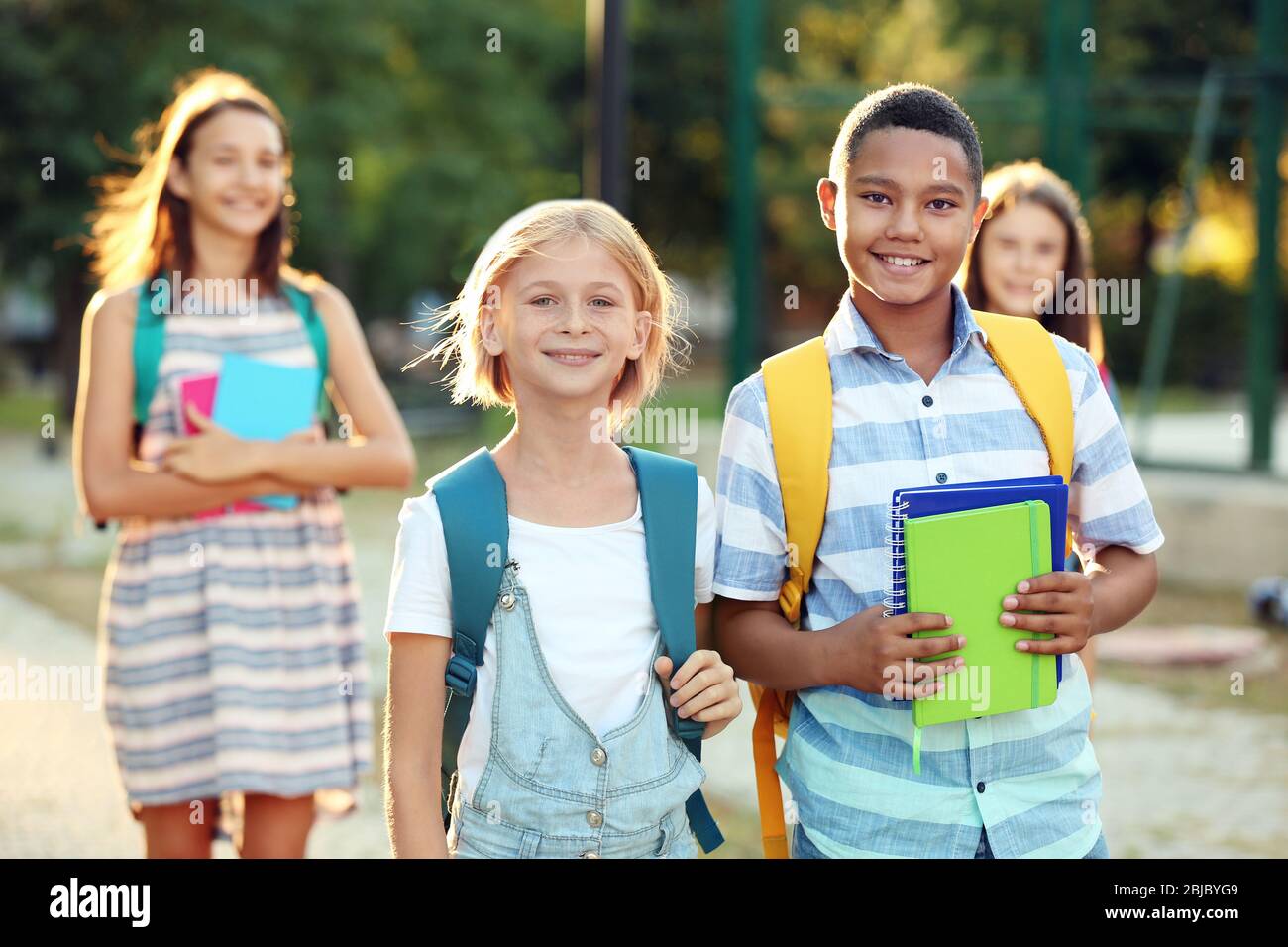 Teenagers with backpacks and notebooks on walking in the park Stock ...