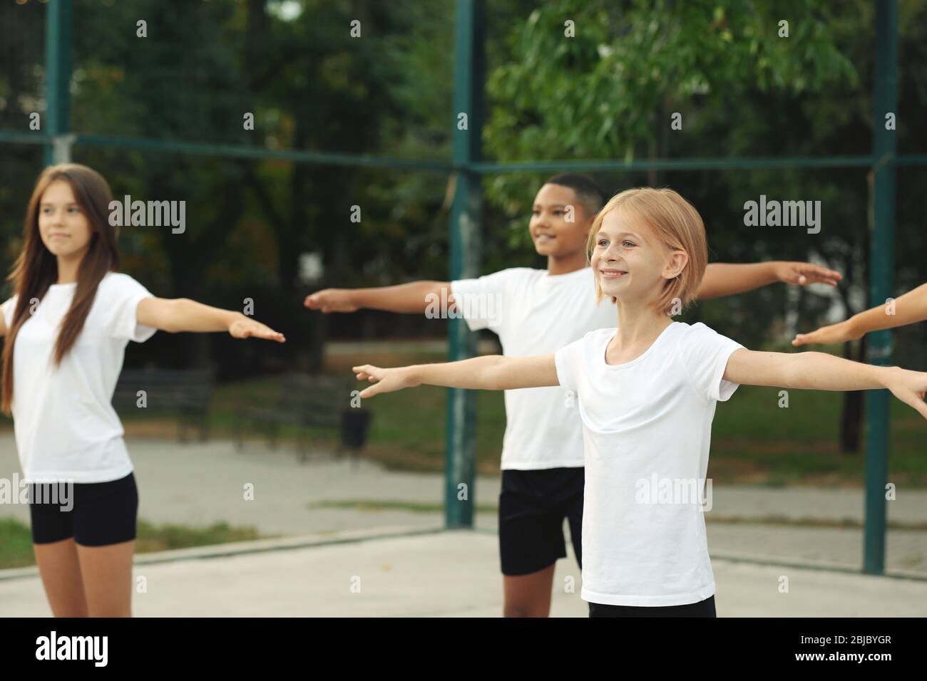 Students doing physical exercises on school yard Stock Photo - Alamy