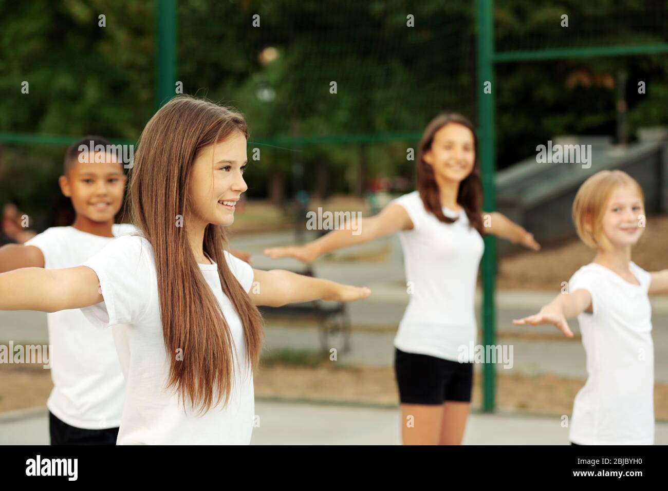 Students doing physical exercises on school yard Stock Photo - Alamy
