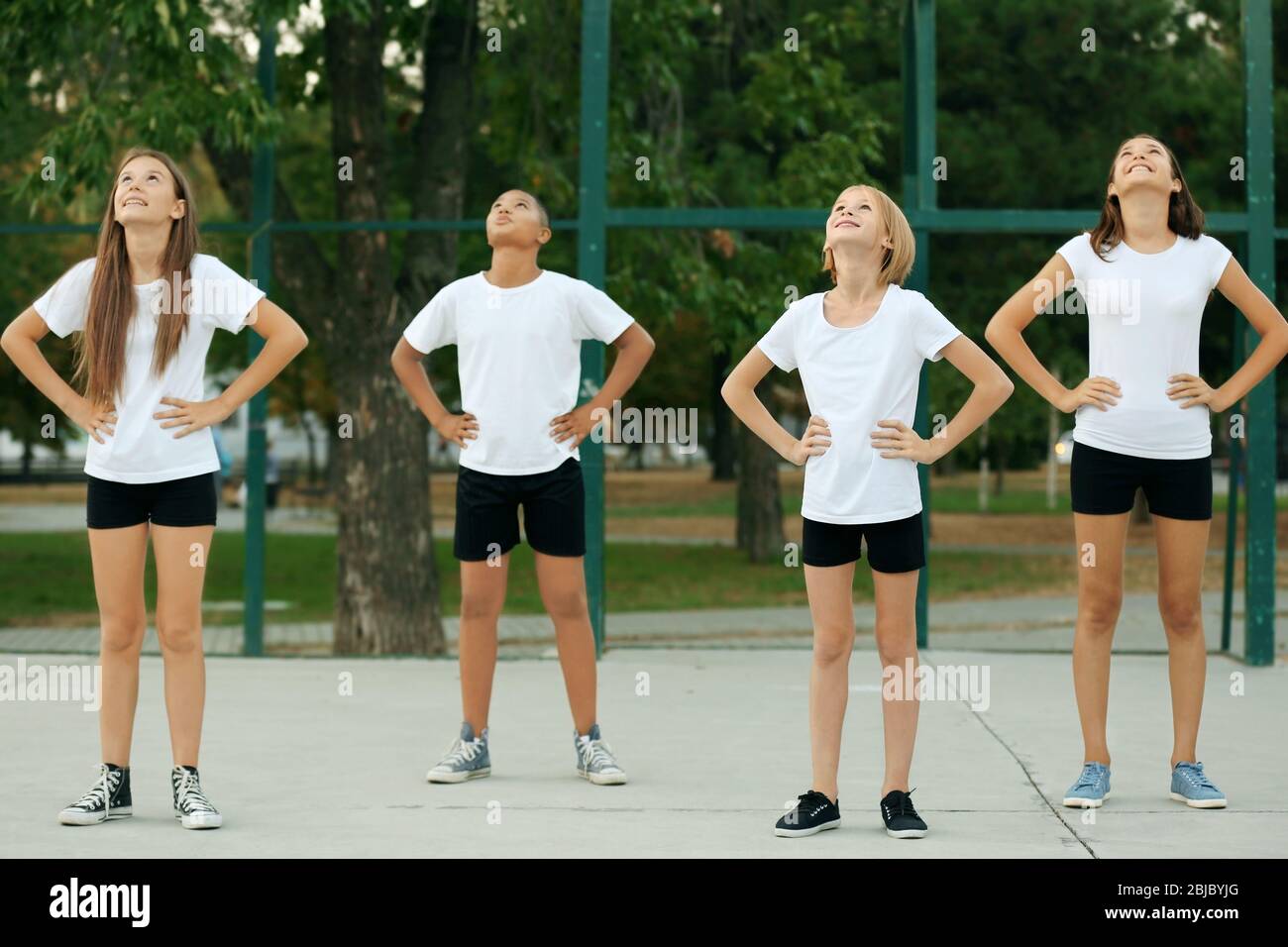Students doing physical exercises on school yard Stock Photo - Alamy