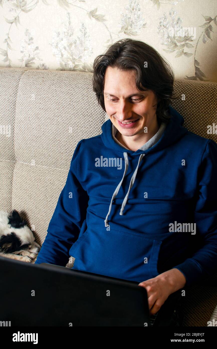 Smiling man using laptop computer for video call friends and parents ...