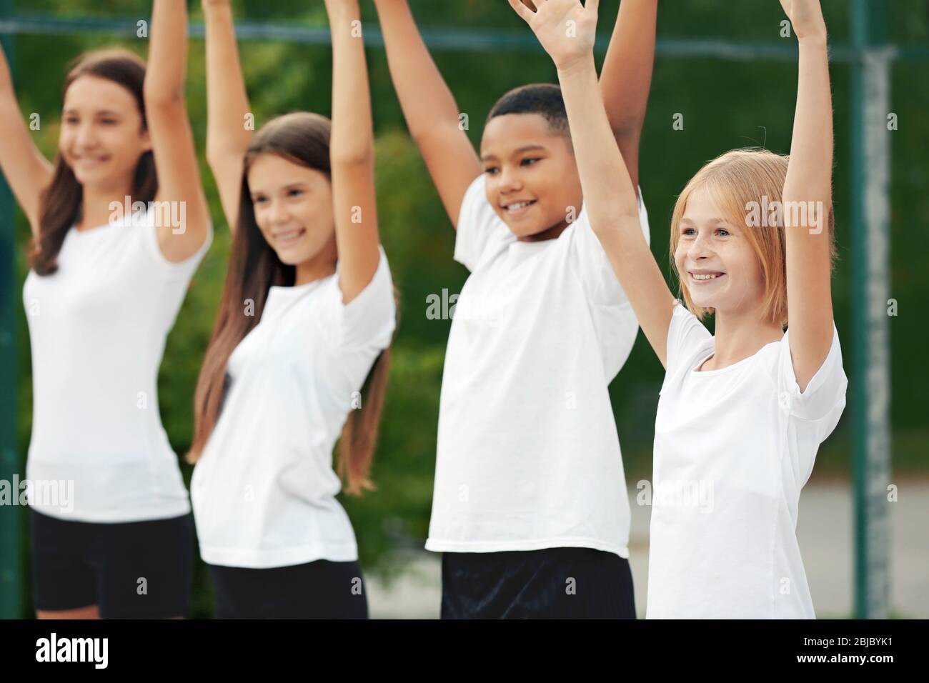 Students doing physical exercises on school yard Stock Photo - Alamy
