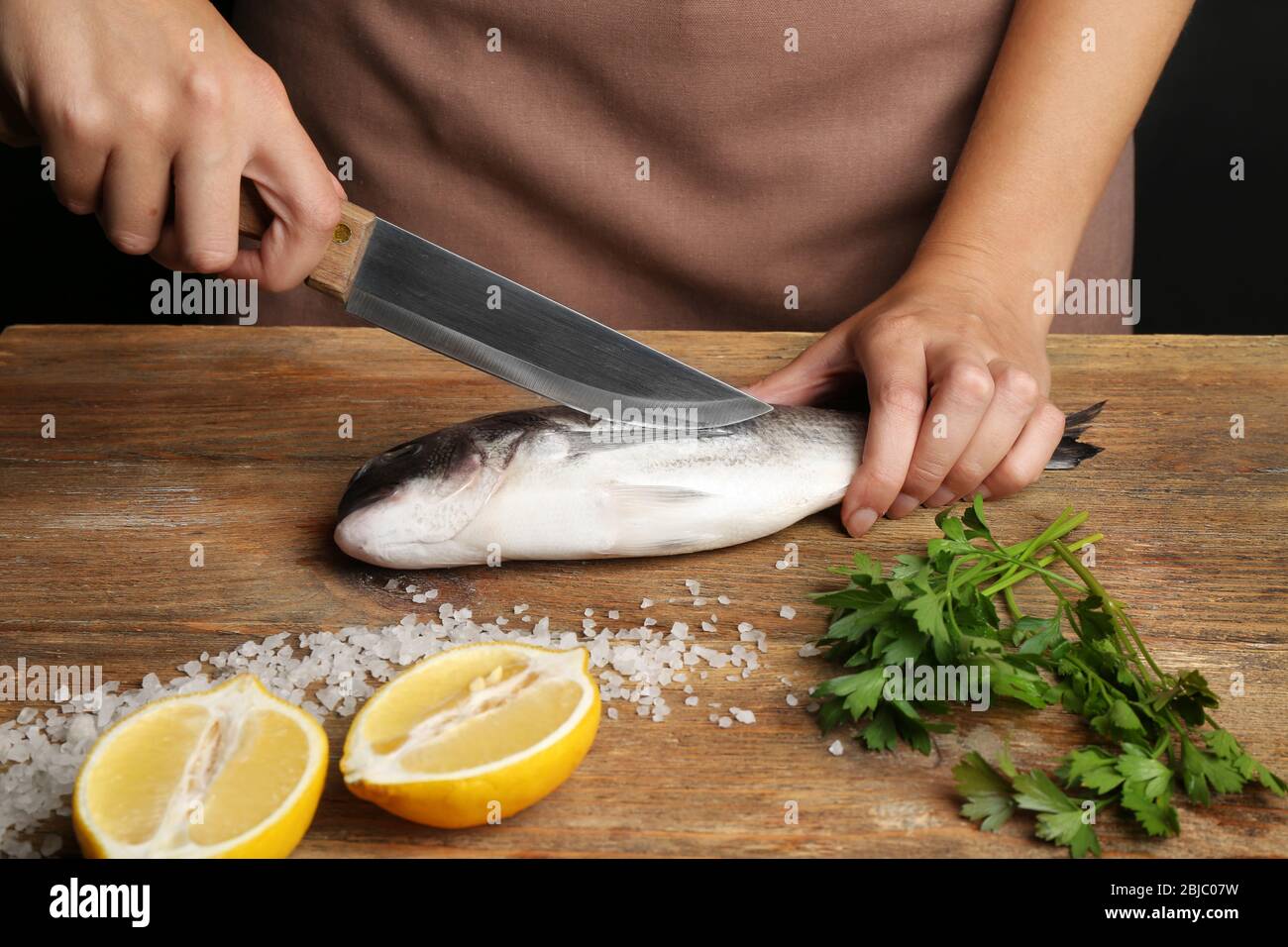 Hands slicing raw fish hi-res stock photography and images - Alamy