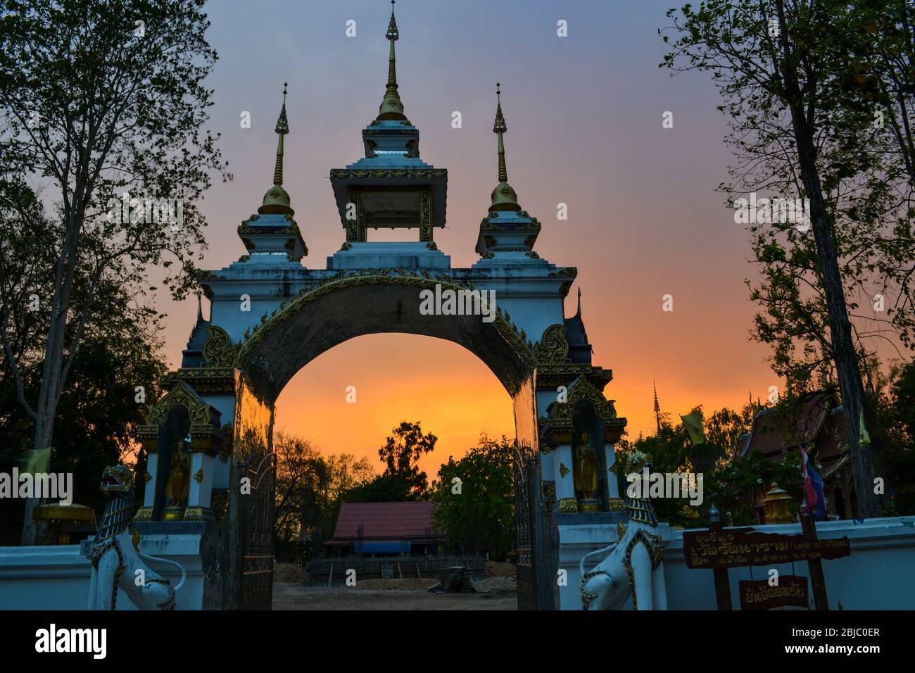 Buddhist temple arch on sunset background Stock Photo - Alamy