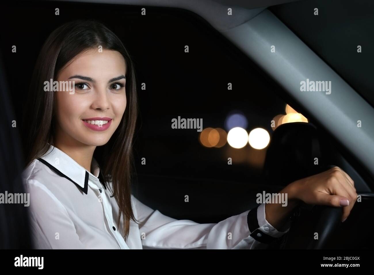 Beautiful girl driving a car Stock Photo - Alamy