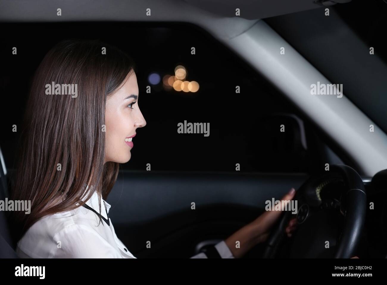 Beautiful girl driving a car Stock Photo - Alamy