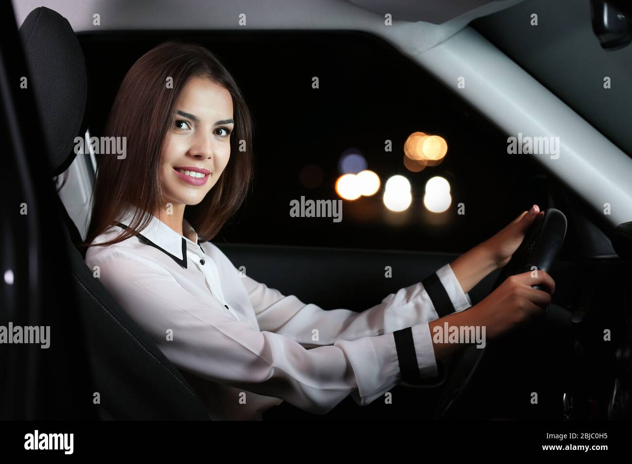 Beautiful girl driving a car Stock Photo - Alamy