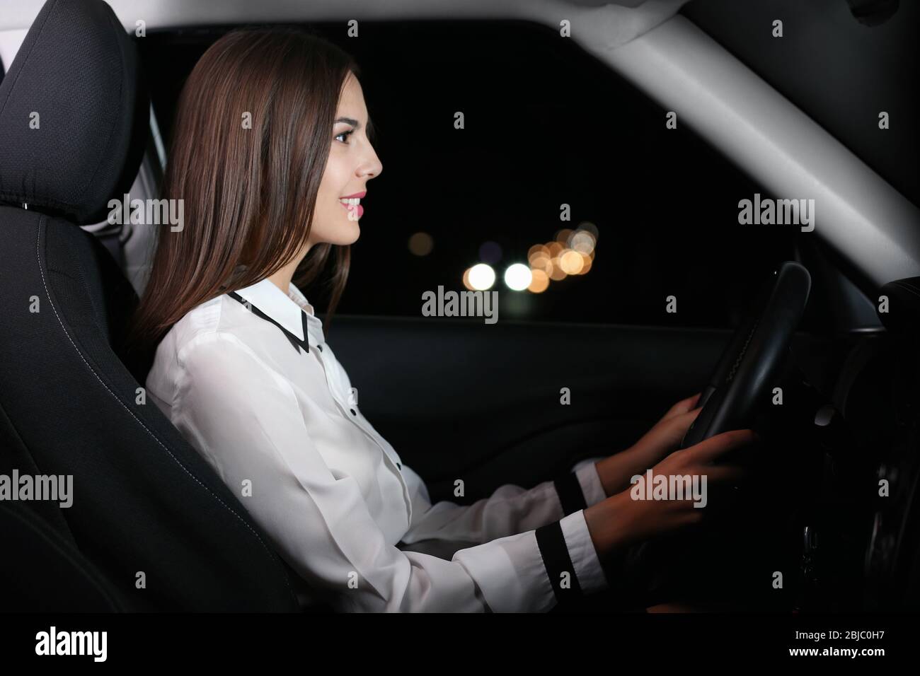 Beautiful girl driving a car Stock Photo - Alamy
