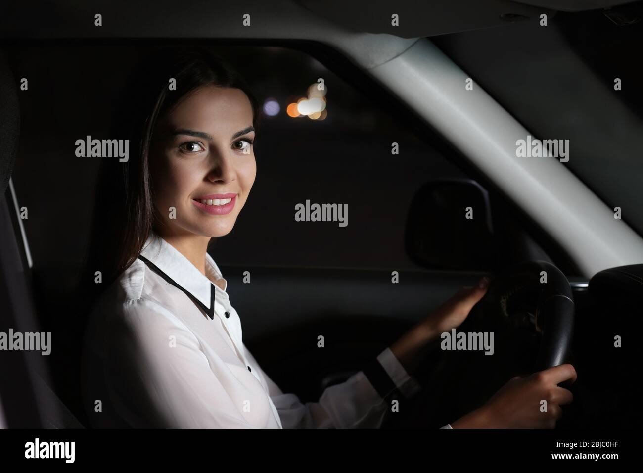 Beautiful girl driving a car Stock Photo - Alamy
