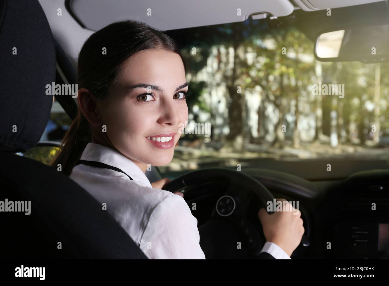 Beautiful girl driving a car Stock Photo - Alamy
