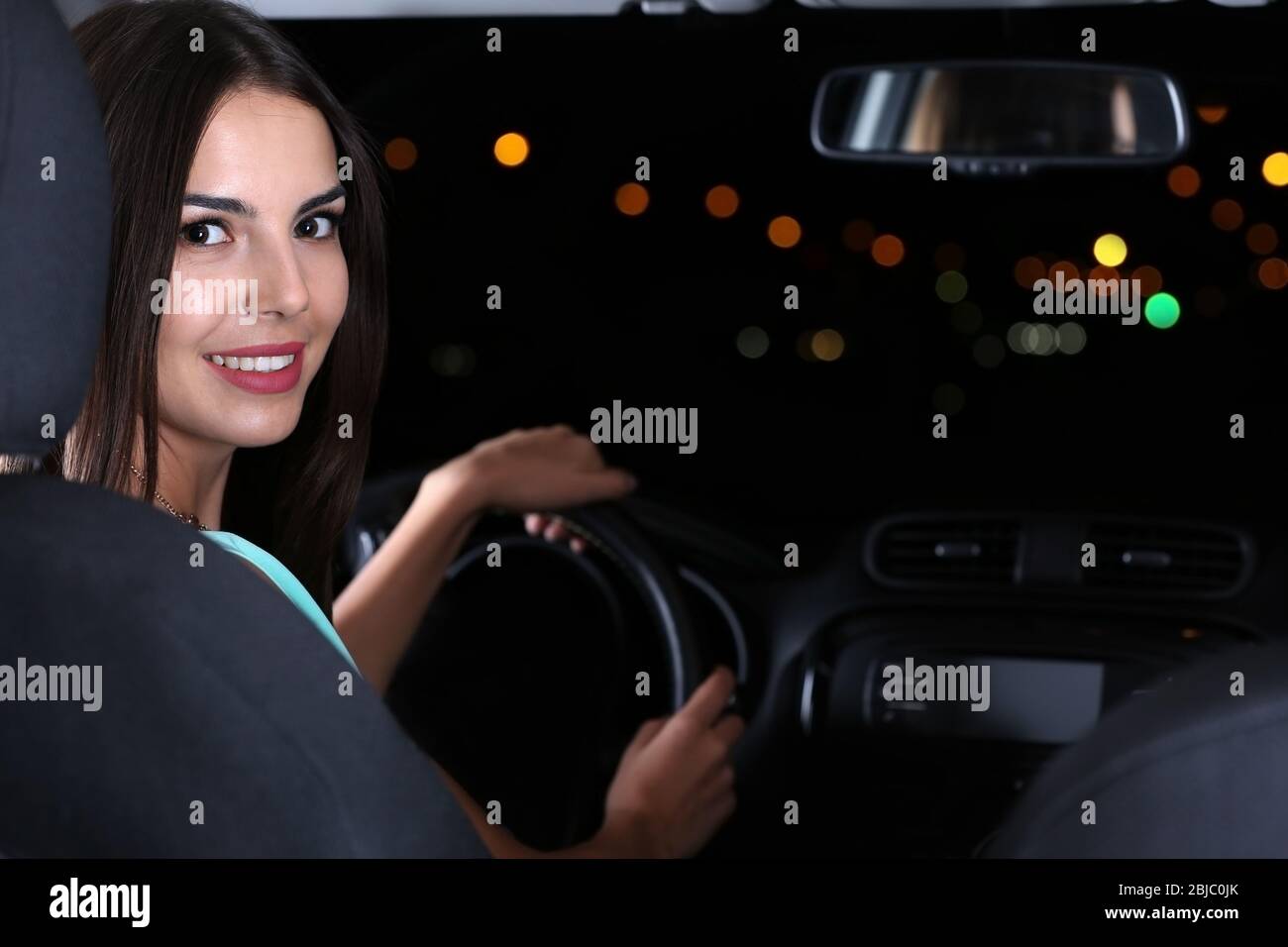 Beautiful girl driving a car Stock Photo - Alamy
