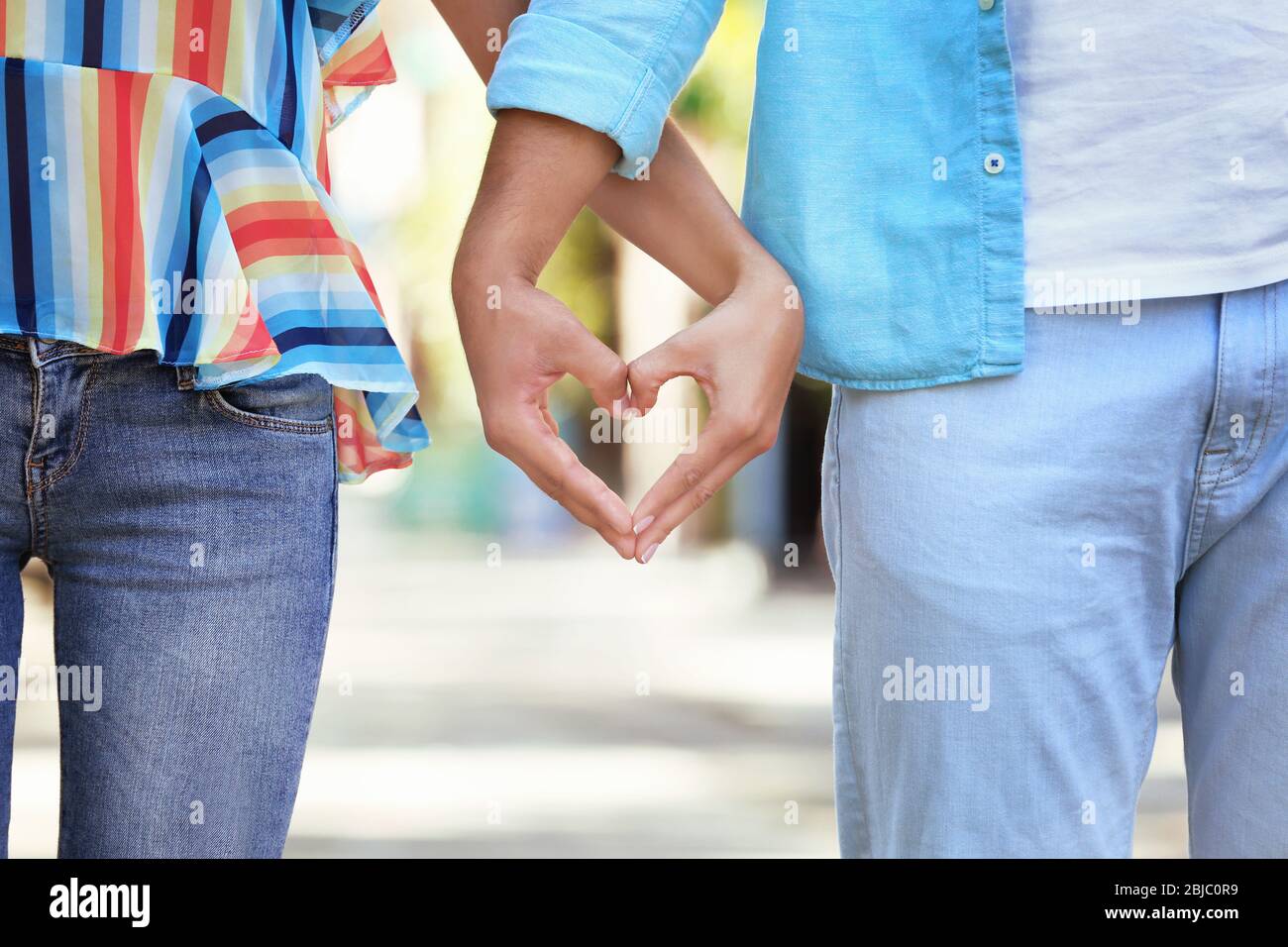 Couple making heart shape with hands Stock Photo - Alamy