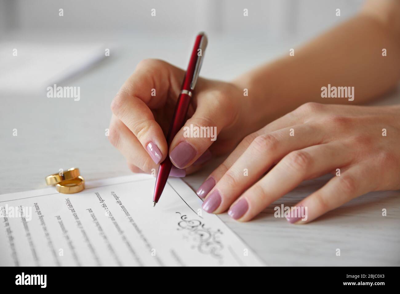 Woman signing marriage contract, closeup Stock Photo - Alamy