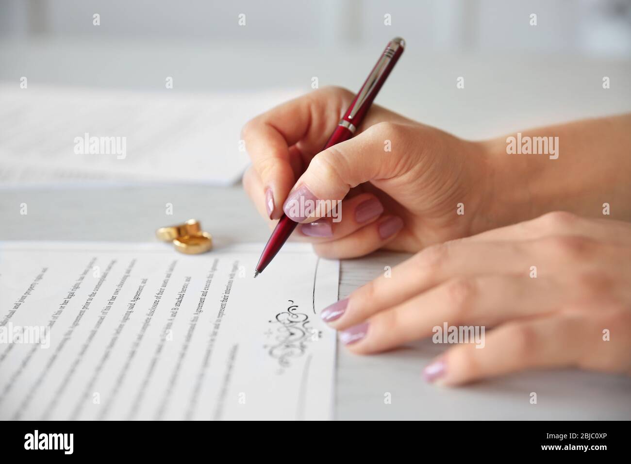 Woman signing prenuptial agreement hi-res stock photography and images ...