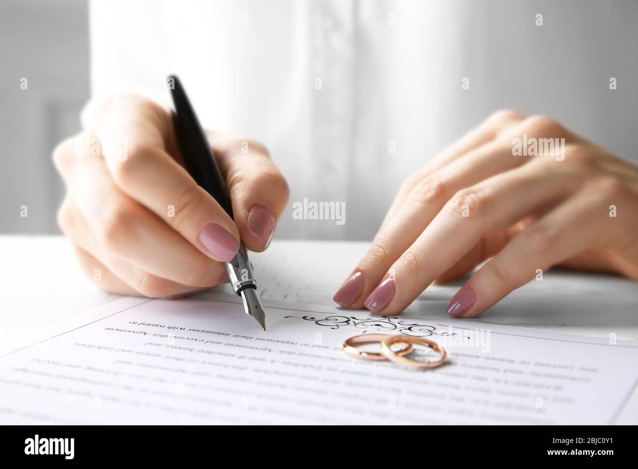Woman signing prenuptial agreement hi-res stock photography and images ...