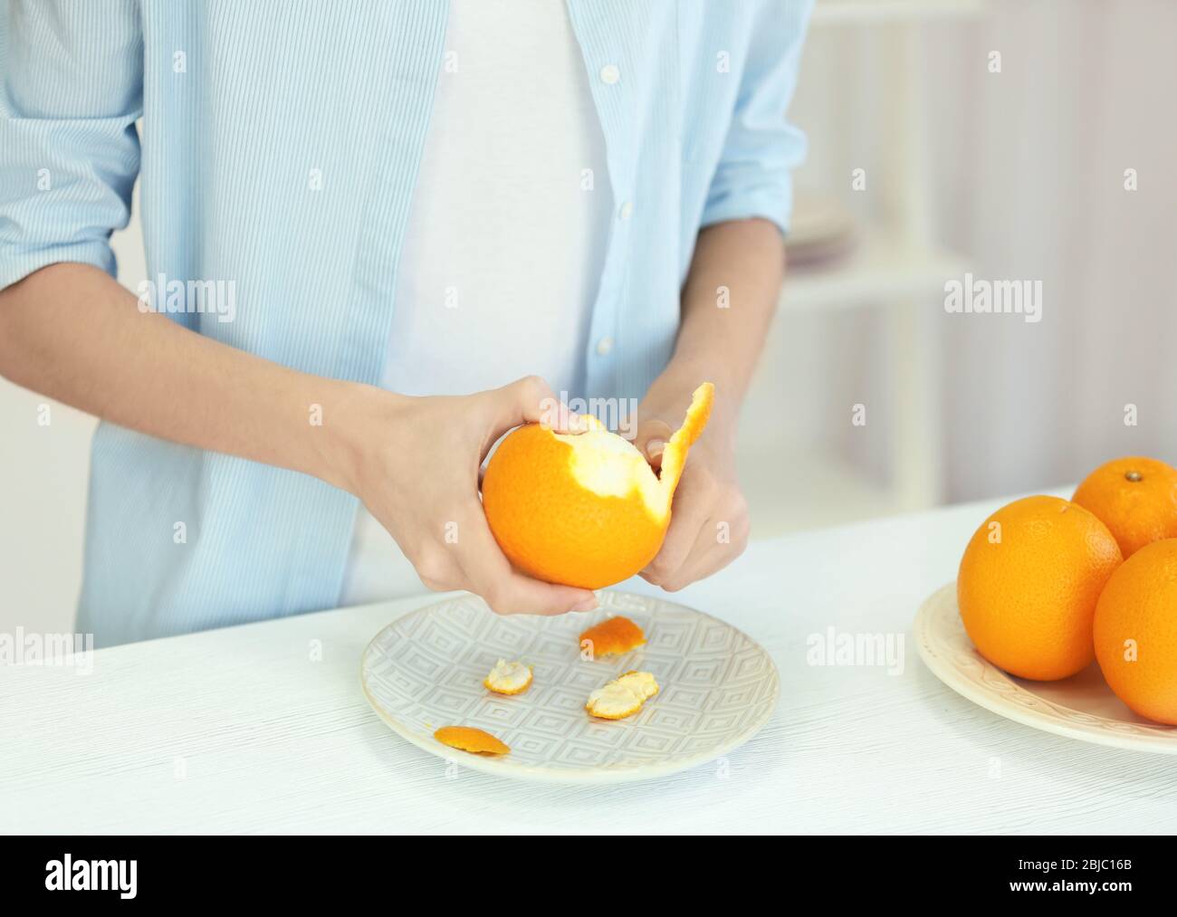 Closeup hands peeling orange fruit hi-res stock photography and images ...