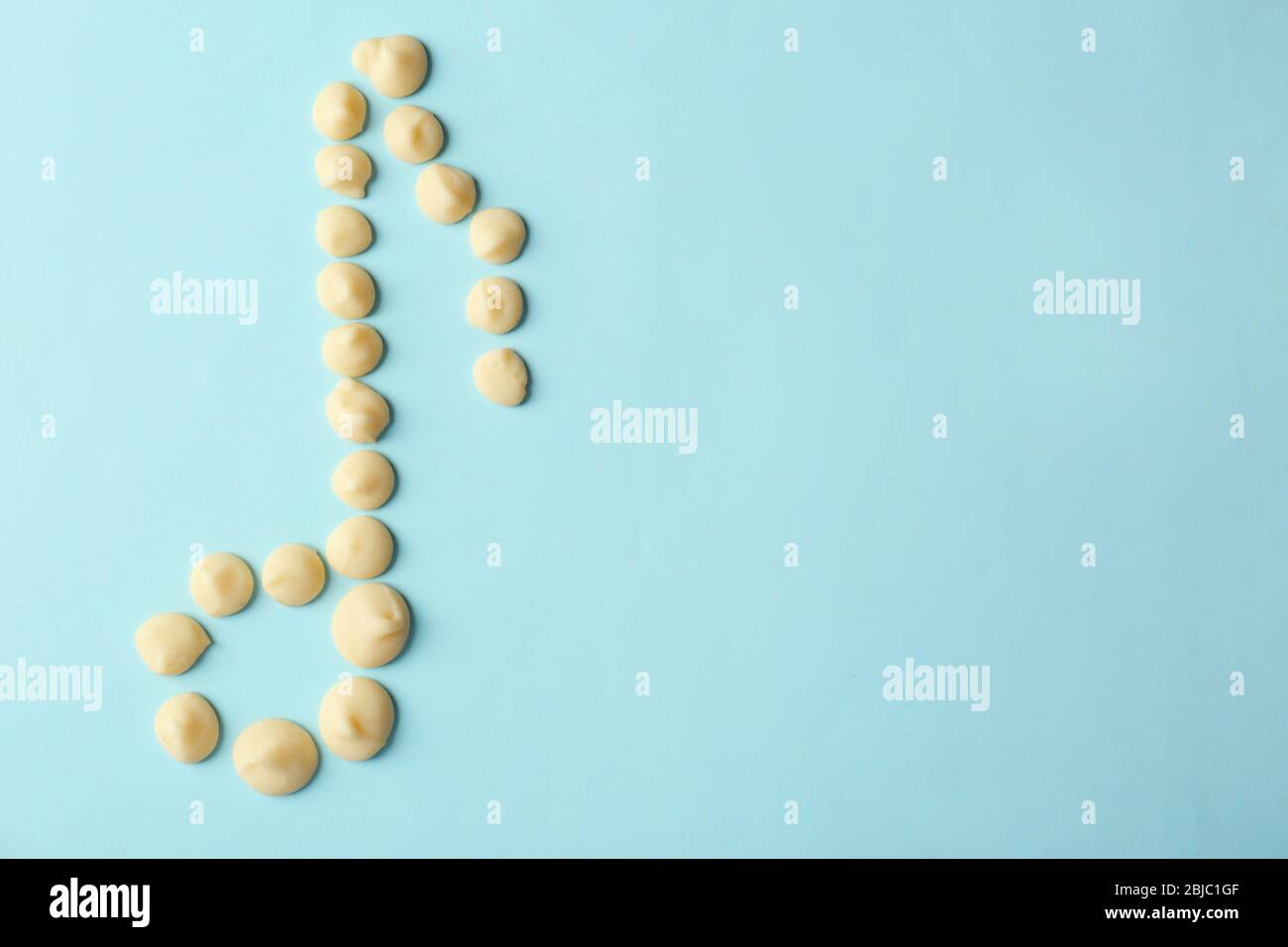 Musical note made of white chocolate on color background Stock Photo ...