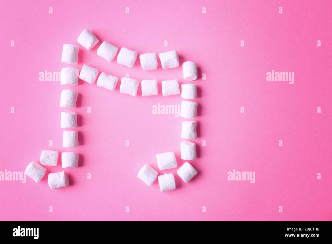 Musical note made of marshmallow on pink background Stock Photo - Alamy
