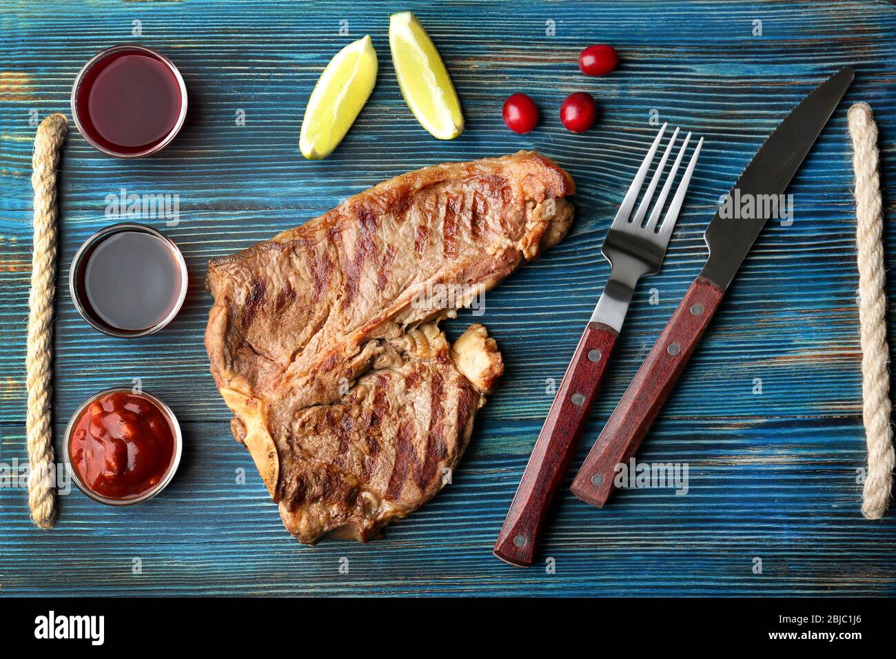 Composition of tasty steak and ingredients on wooden background Stock ...