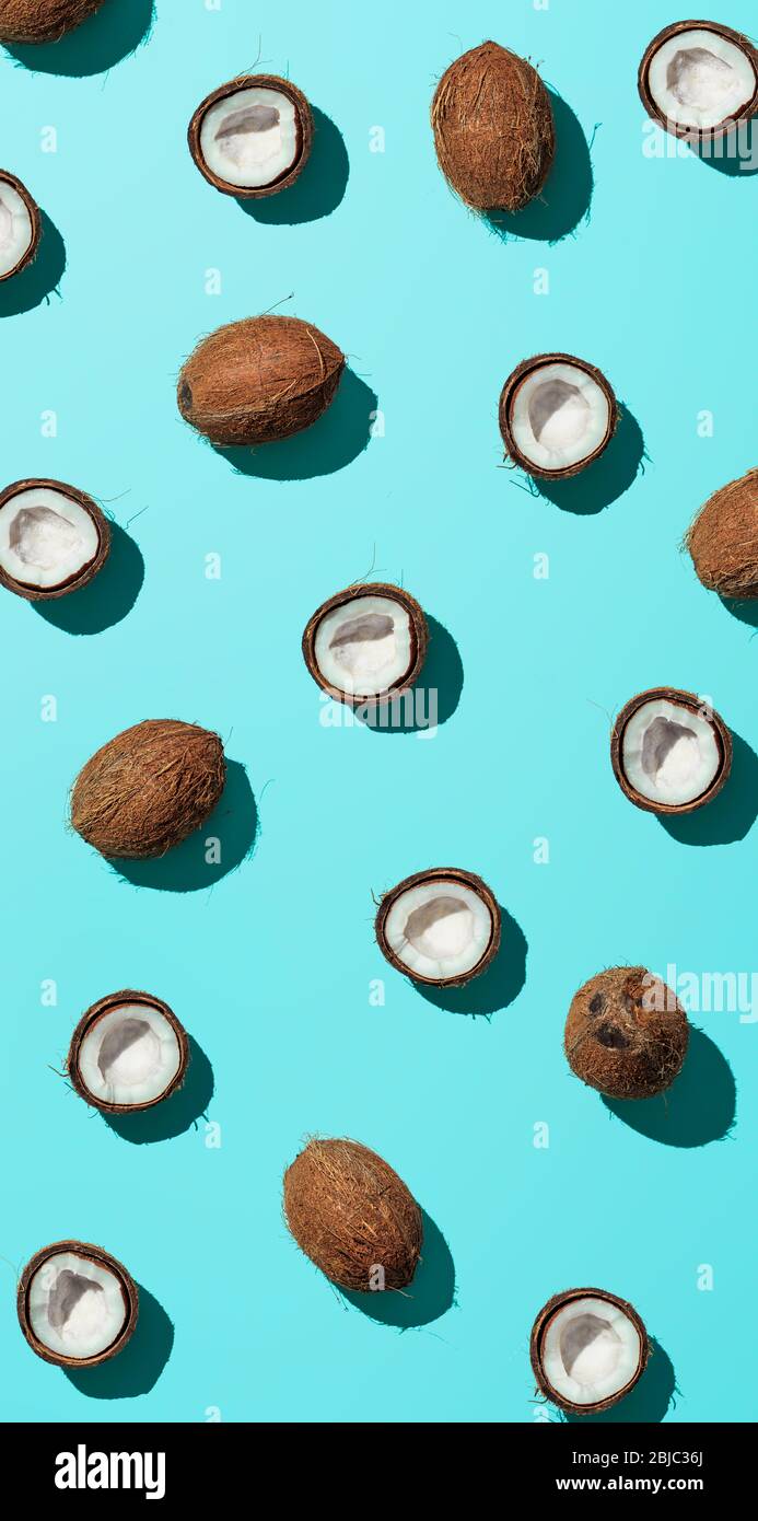 Creative layout of coconuts half on blue background. Tropical pattern ...
