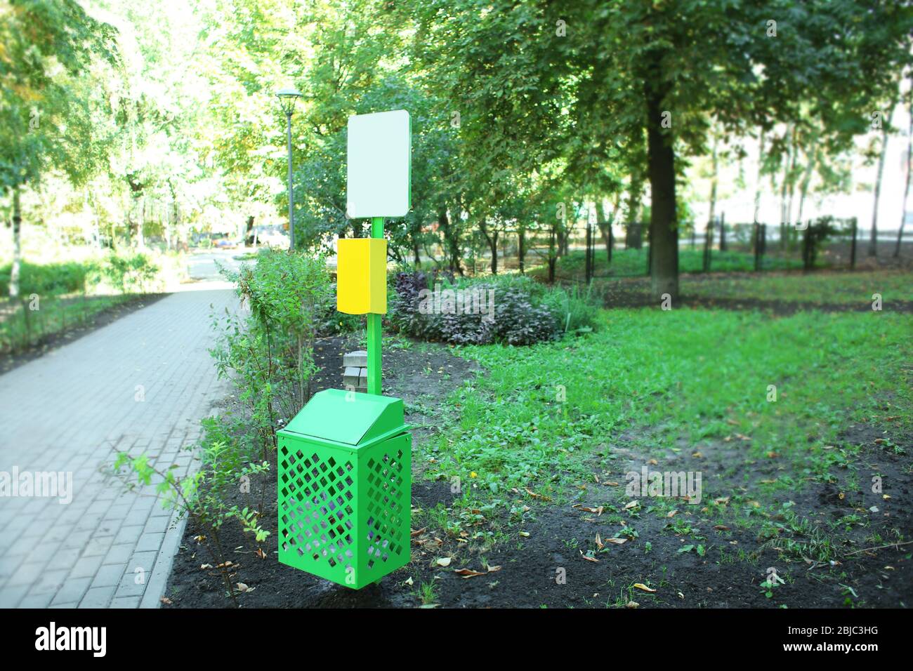 Dog poop bin in modern city park Stock Photo - Alamy