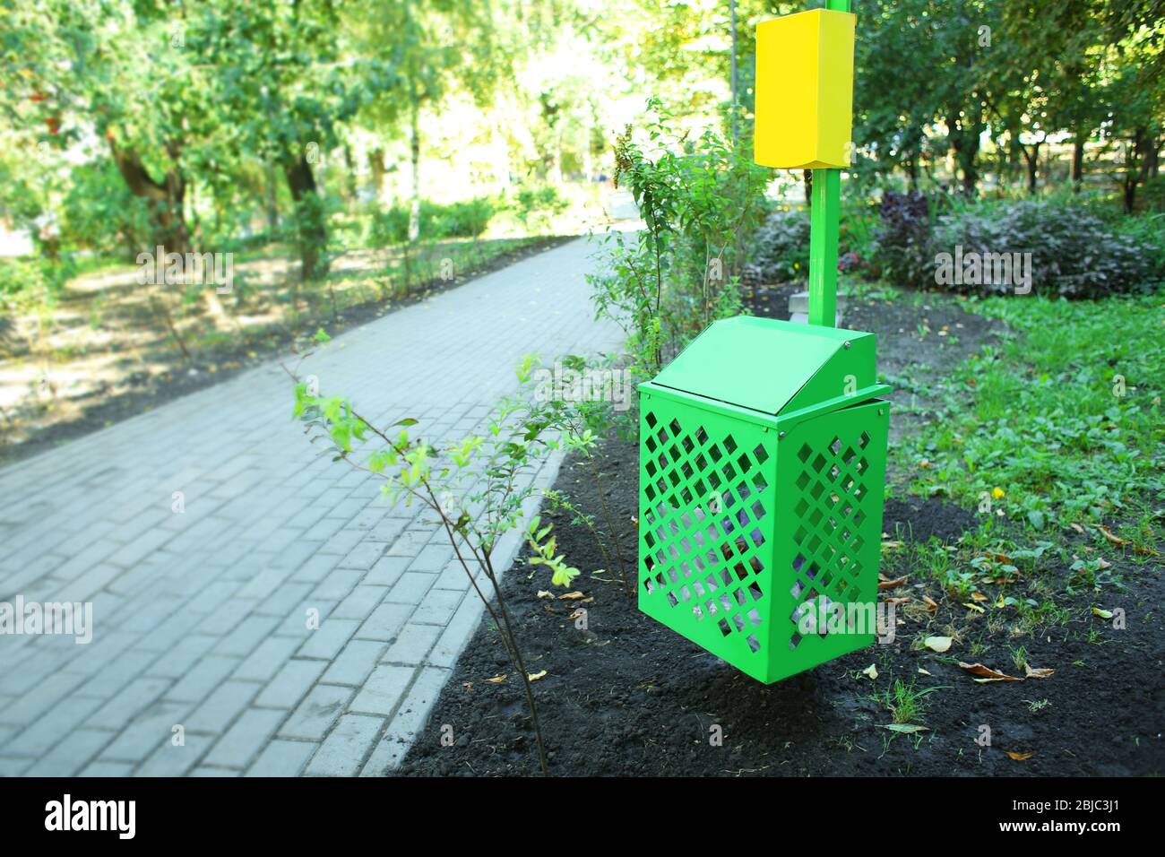 Dog poop bin in modern city park Stock Photo - Alamy