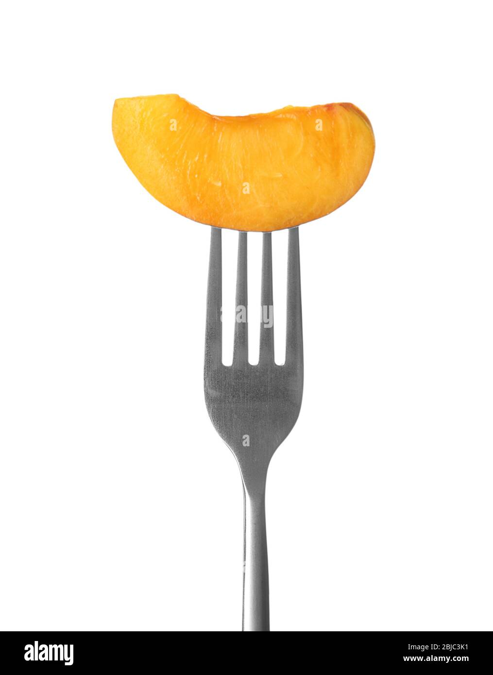 Fork with peach slice on white background Stock Photo - Alamy