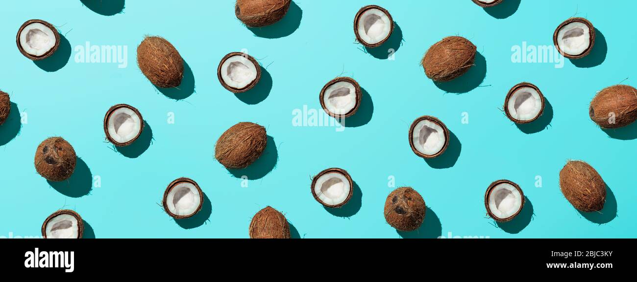 Creative layout of coconuts half on blue background. Tropical pattern ...