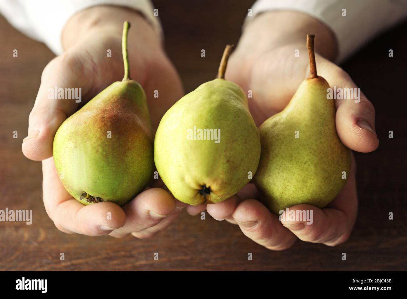 Man hand holding pear hi-res stock photography and images - Alamy
