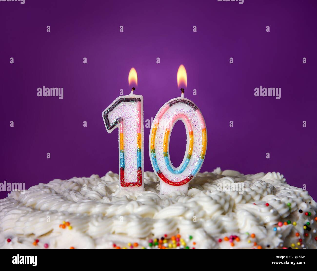 Tasty cake with candles for tenth birthday on purple background Stock ...