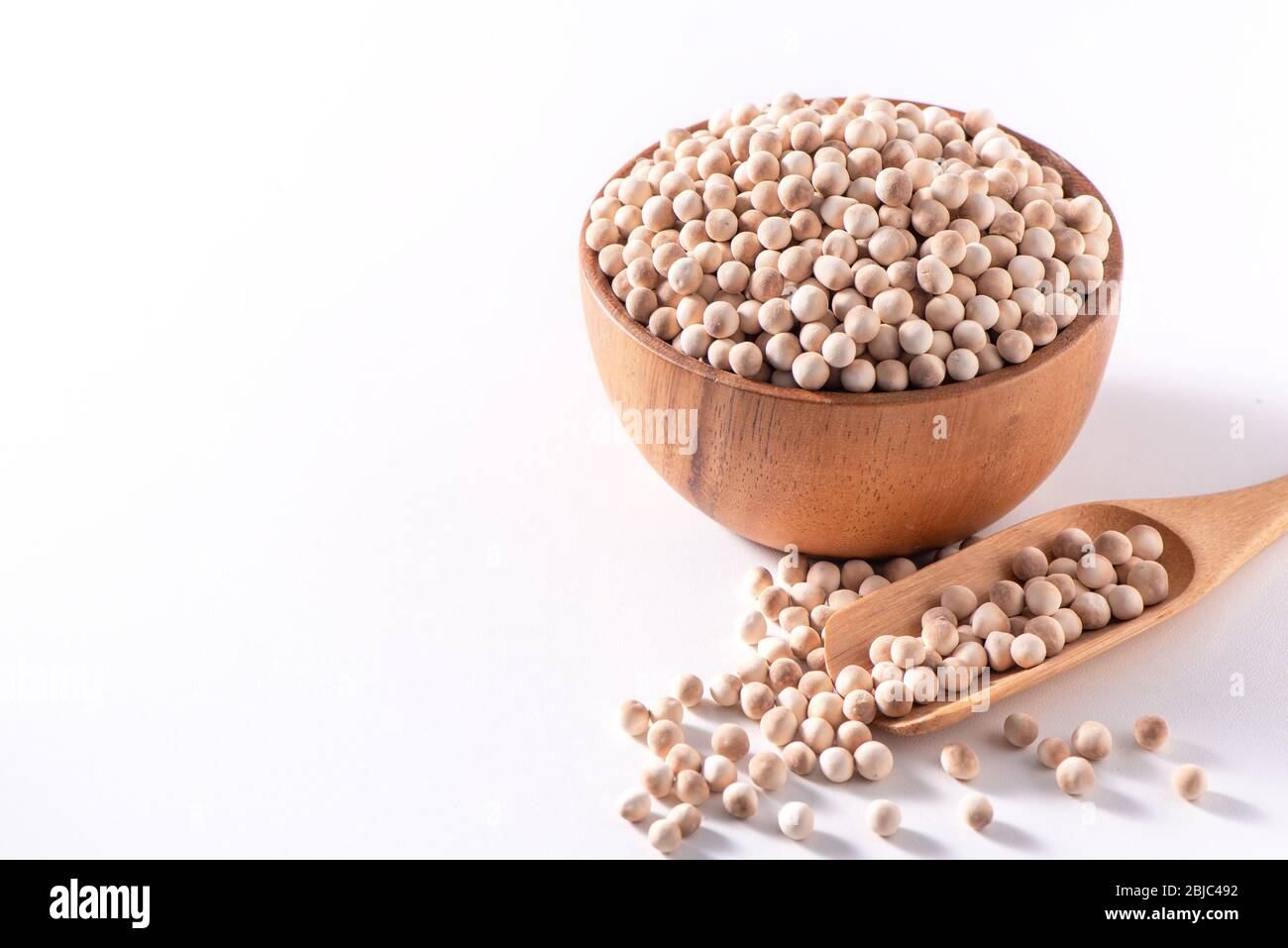 Dry raw brown tapioca pearls in a wooden bowl with spoon isolated on ...