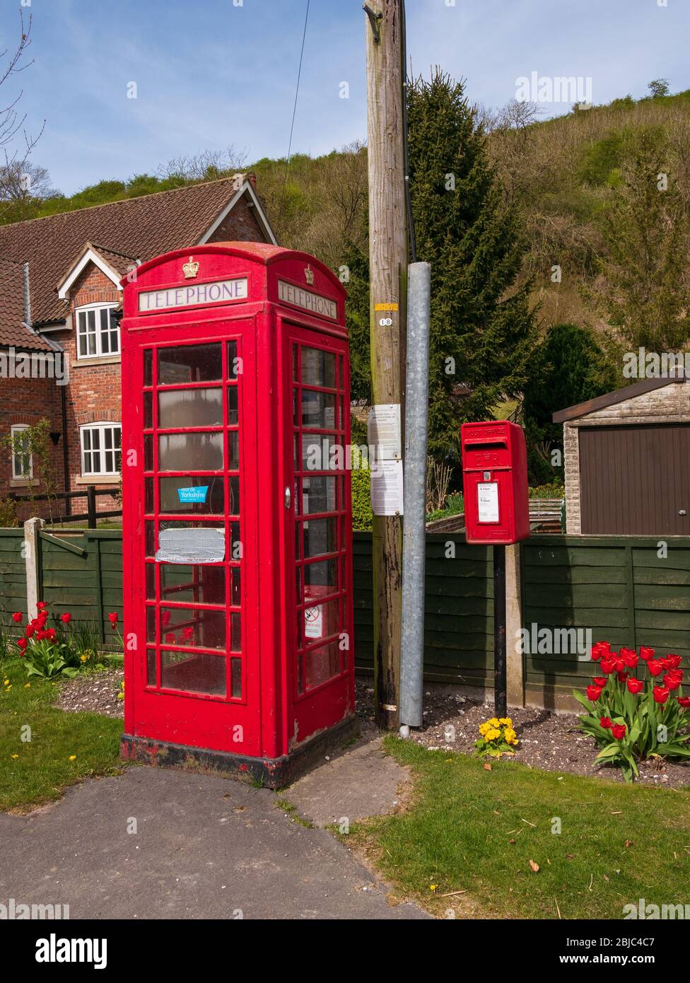 A red telephone box and a red ER post box next to each other in the ...