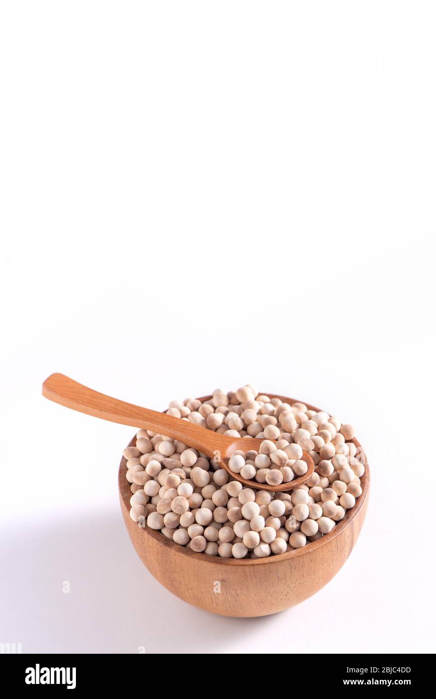 Dry raw brown tapioca pearls in a wooden bowl with spoon isolated on ...