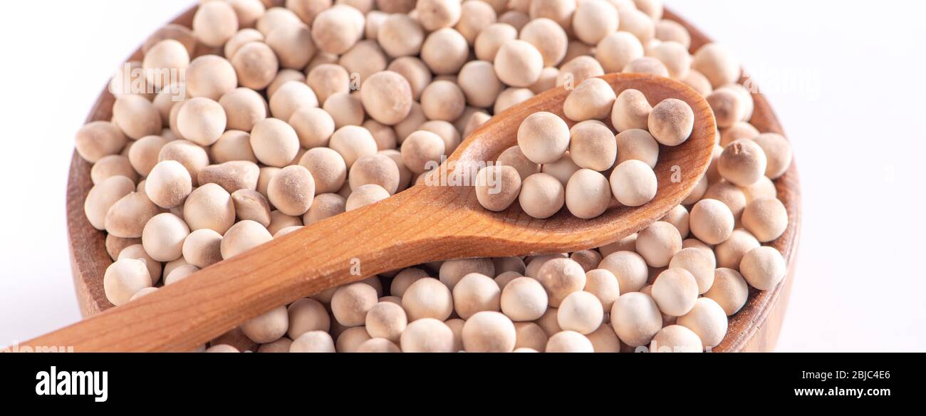 Dry raw brown tapioca pearls in a wooden bowl with spoon isolated on ...