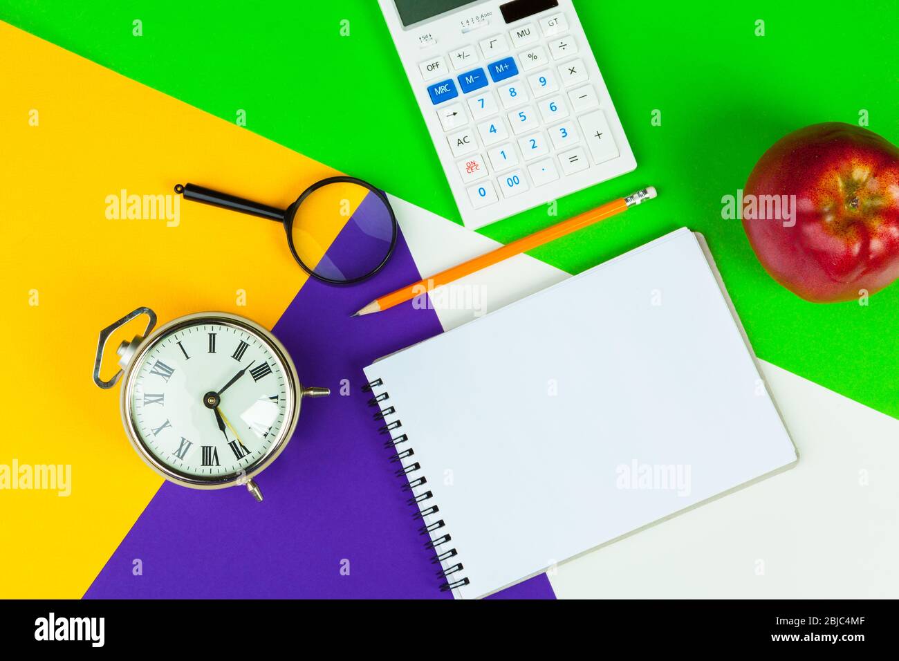 Black alarm clock on color block background, office interior Stock ...