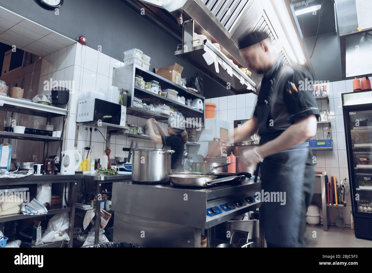 Behind the scenes of brands. The chef cooking in a professional kitchen ...