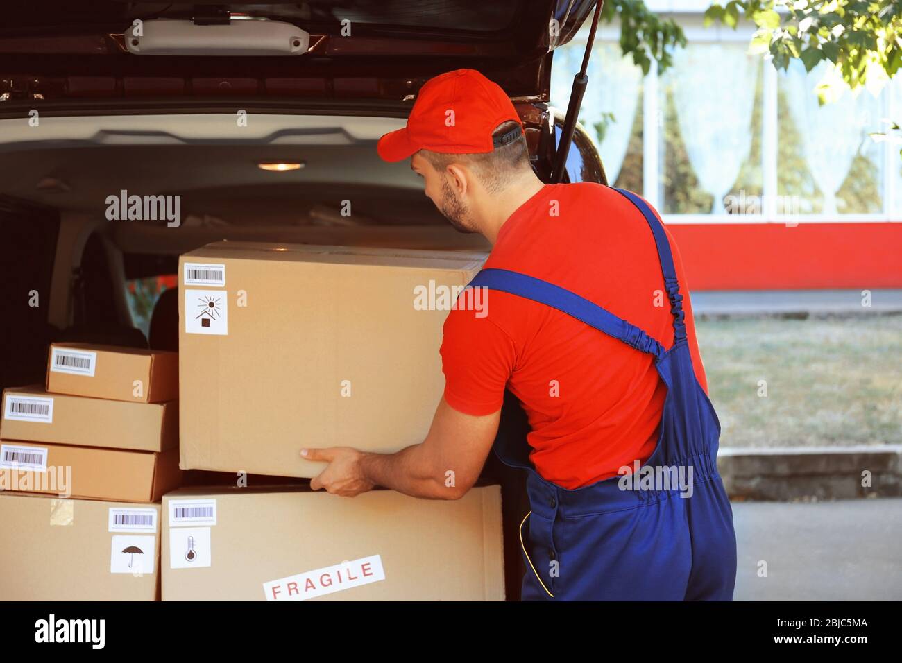 Manual worker box unloading transportation hi-res stock photography and ...