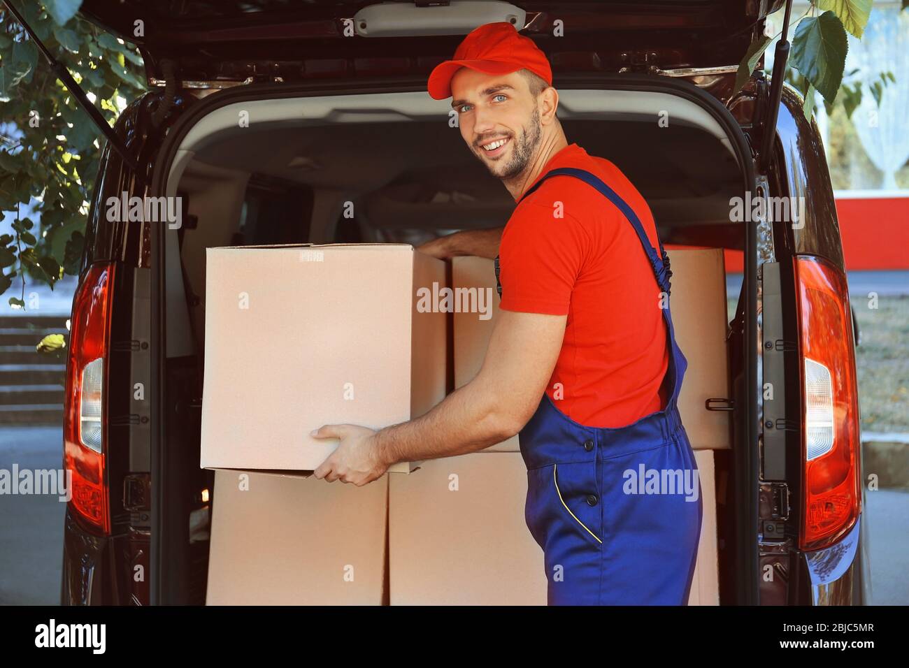 Manual worker box unloading transportation hi-res stock photography and ...