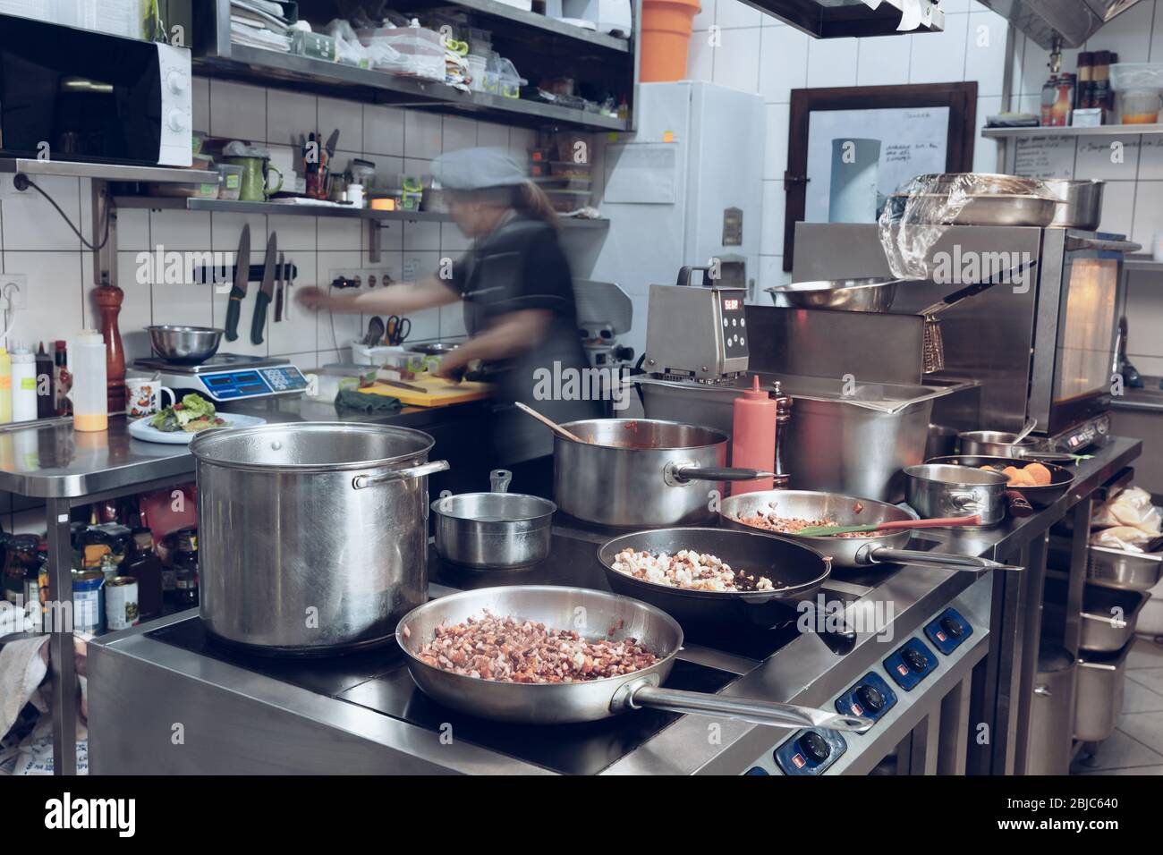 Behind the scenes of brands. The chef cooking in a professional kitchen ...